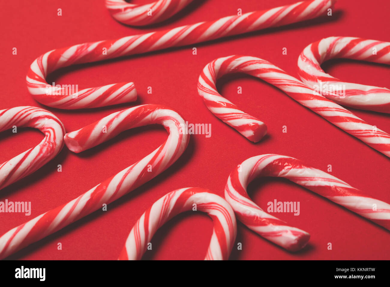 Christmas festive candy cane on a red background Stock Photo - Alamy