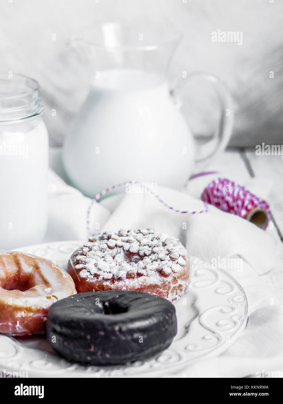 Milk And Assorted Donuts On Rustic Wooden Background Stock Photo - Alamy