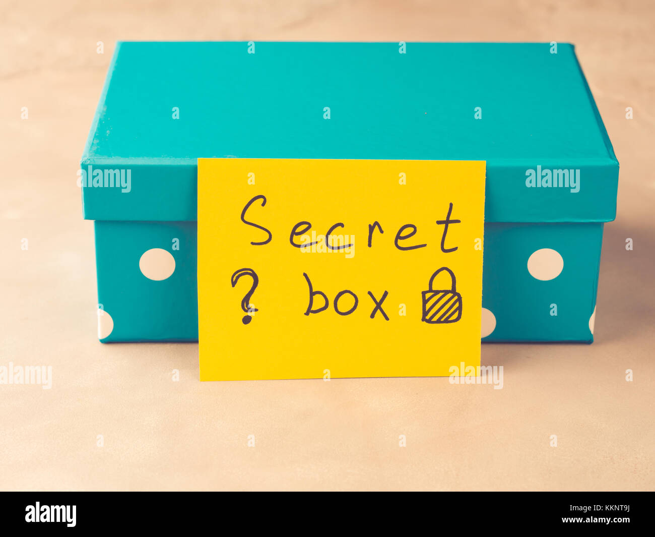 Blue gift with yellow paper card hand written Secret box. Surprise ...