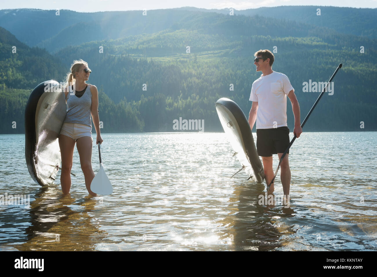 Man carrying stand up paddleboard hi-res stock photography and images ...