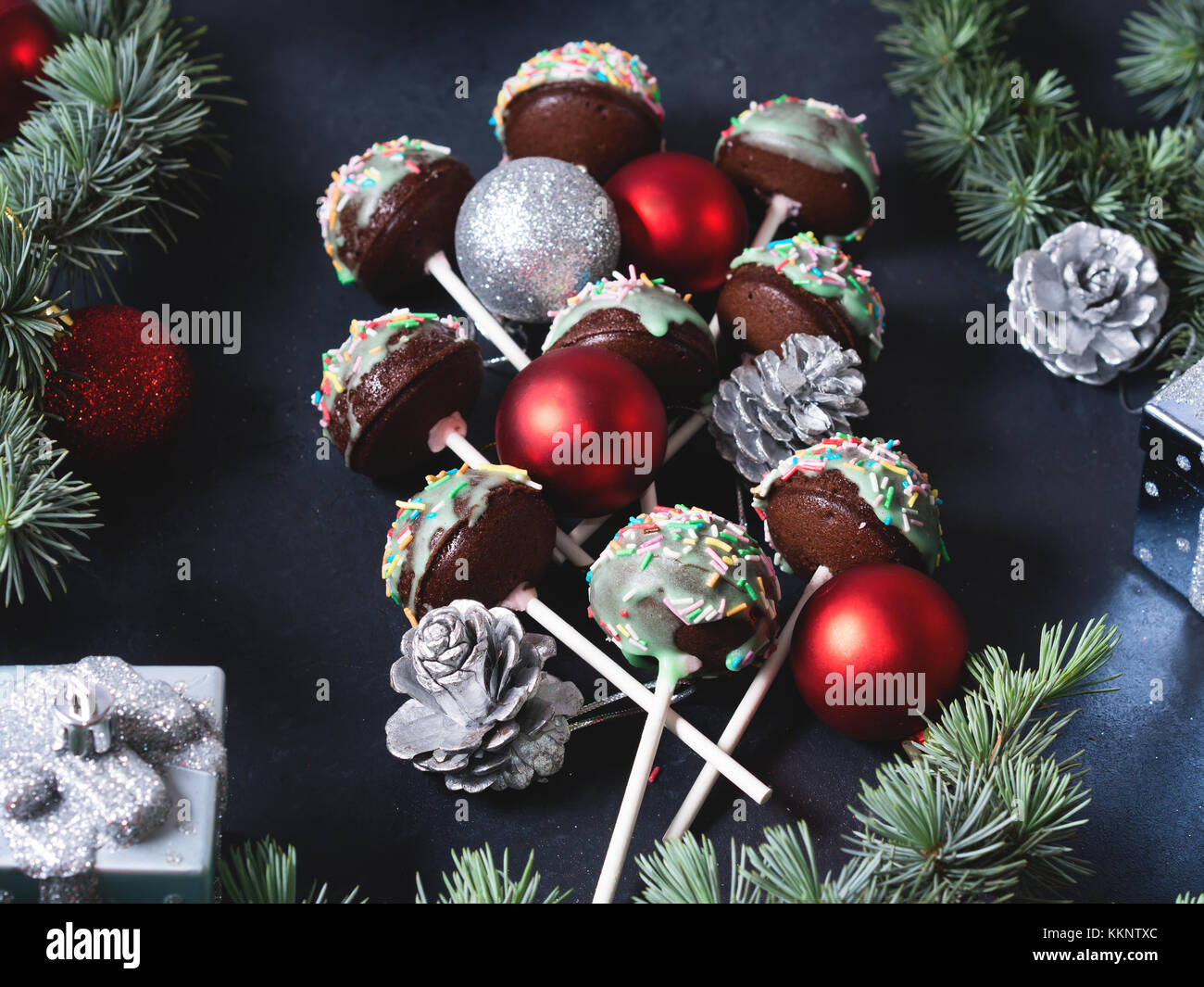 Christmas tree branches with baubles and cake pops tree with colored ...
