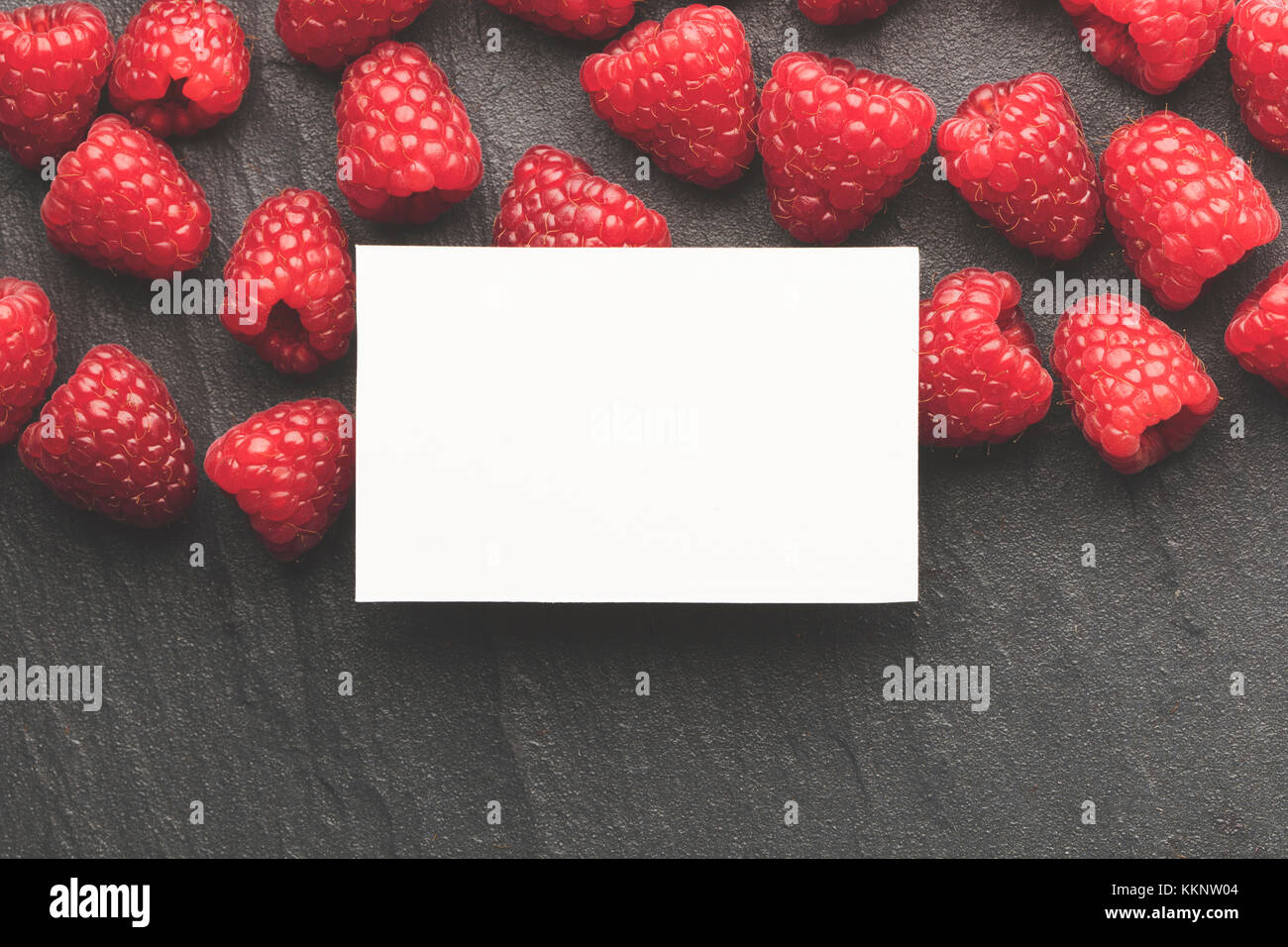 Fresh red raspberries background with blank white sign Stock Photo - Alamy