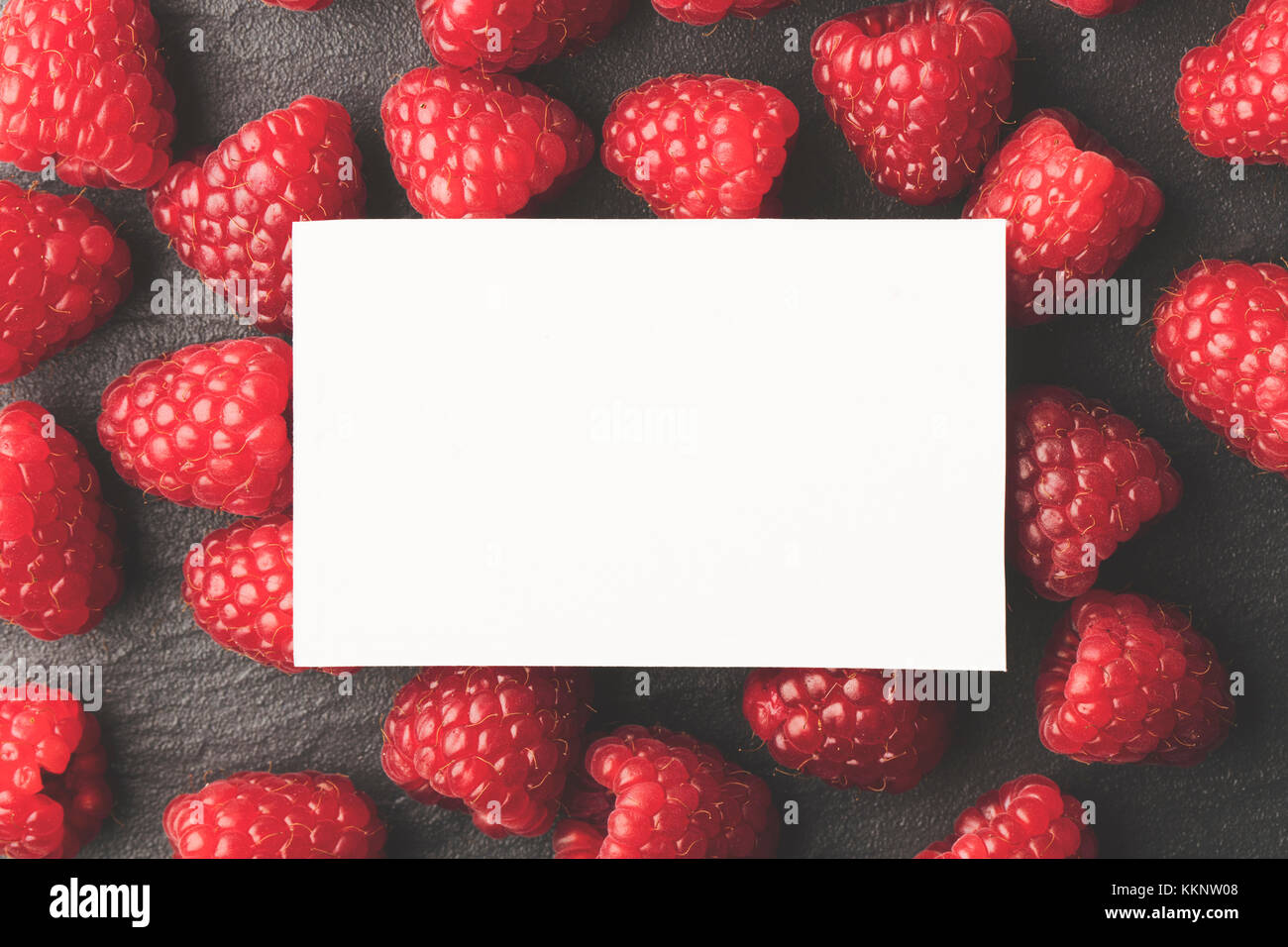 Fresh red raspberries background with blank white sign Stock Photo - Alamy