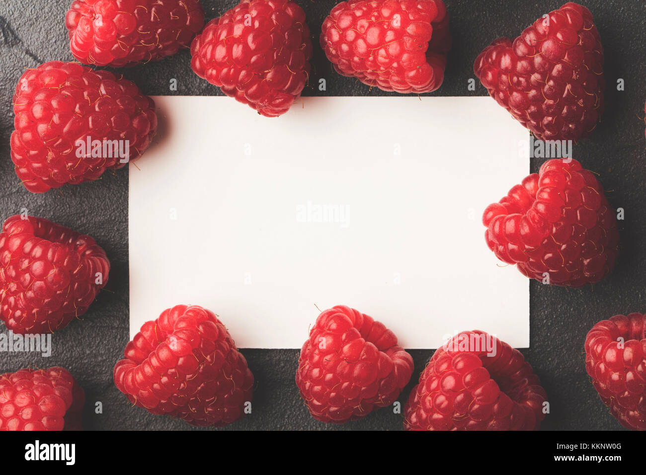 Fresh red raspberries background with blank white sign Stock Photo - Alamy
