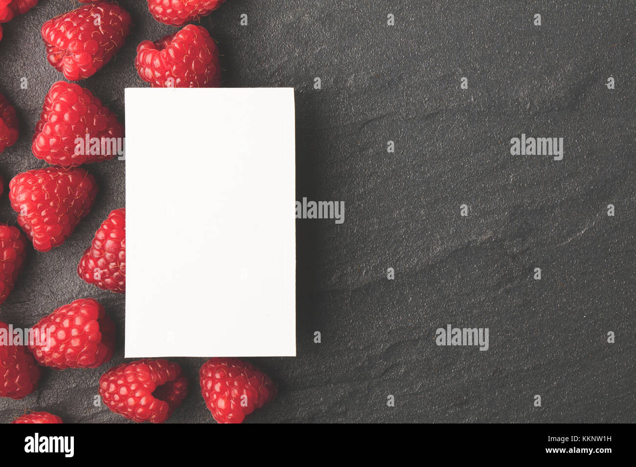 Fresh red raspberries background with blank white sign Stock Photo - Alamy