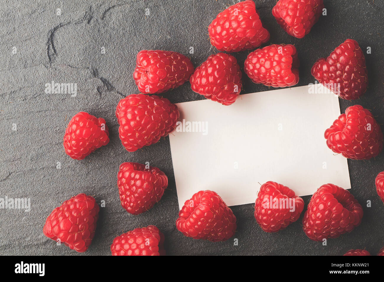 Fresh red raspberries background with blank white sign Stock Photo - Alamy