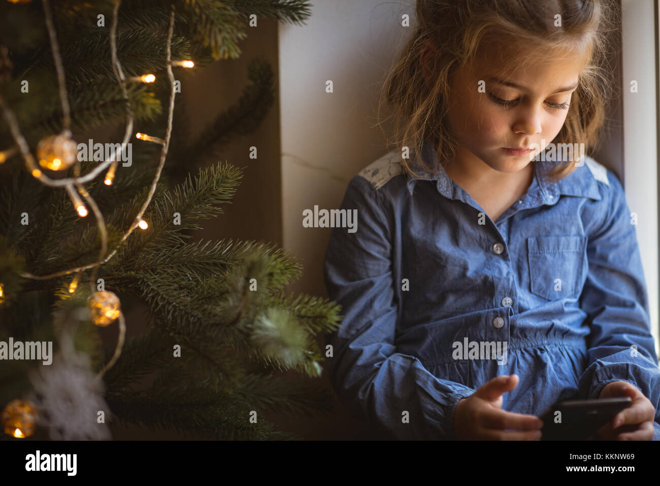 Girl using mobile phone at home Stock Photo - Alamy