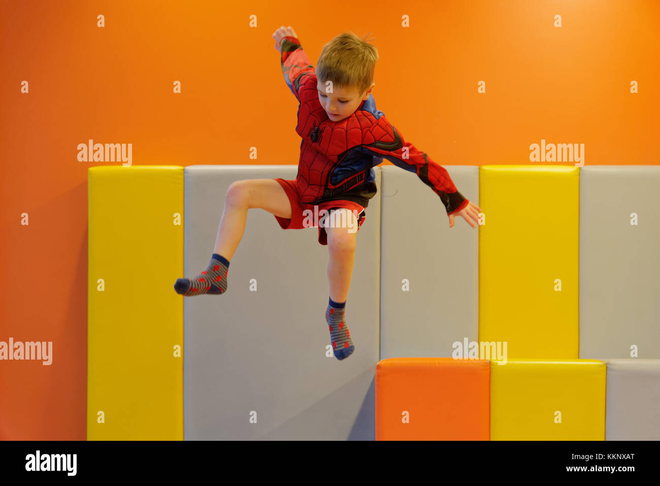 A little boy (5 yrs old) jumping in a padded play area Stock Photo - Alamy
