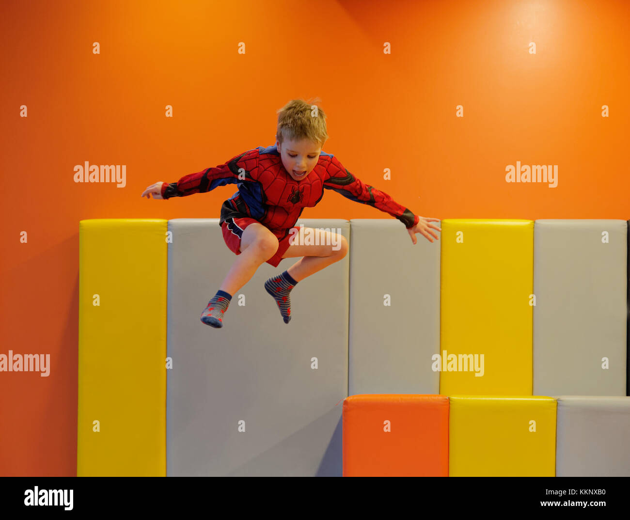 A little boy (5 yrs old) jumping in a padded play area Stock Photo - Alamy