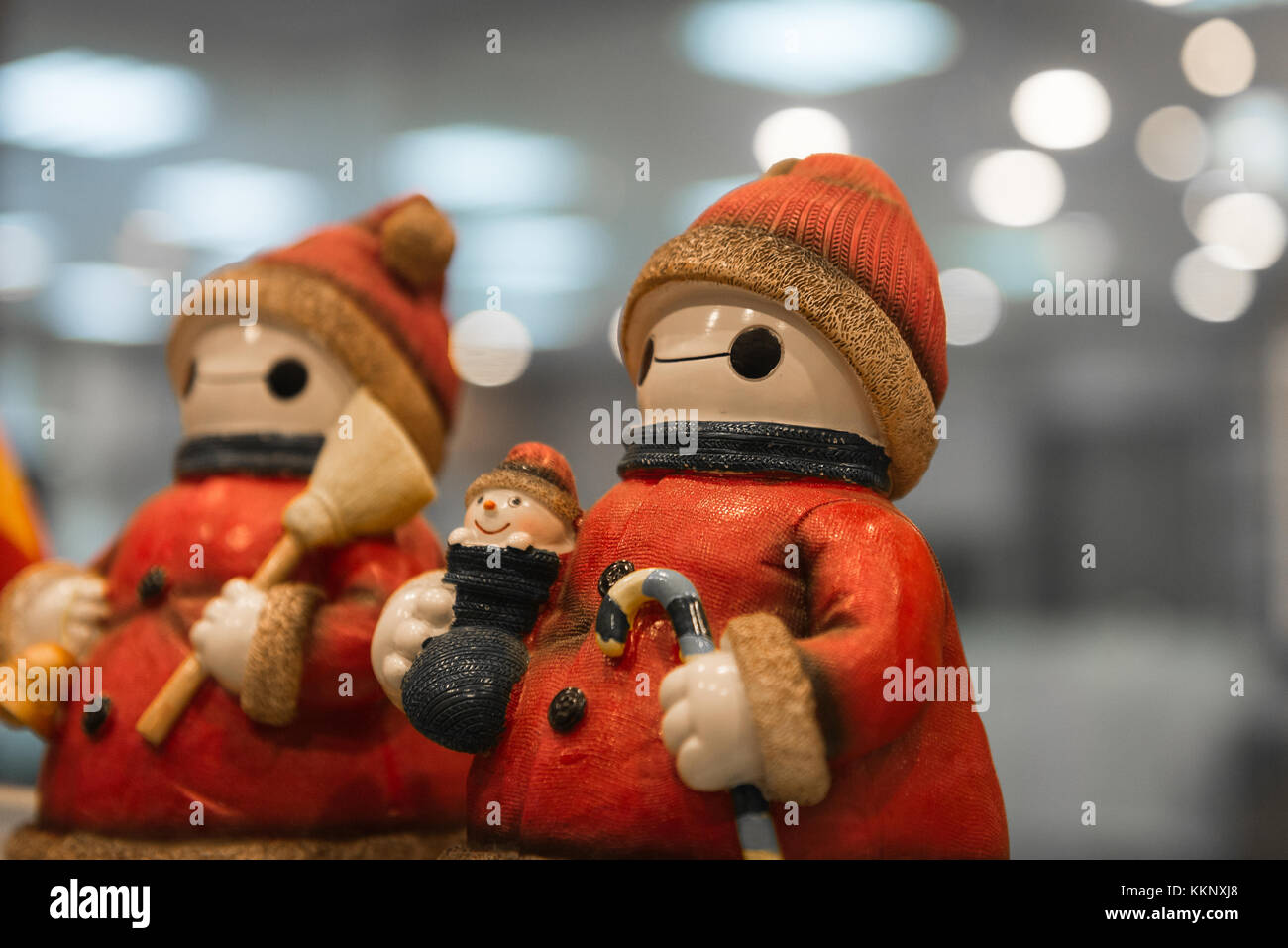 Two Santa claus happy smiling statue standing together and hold a child ...