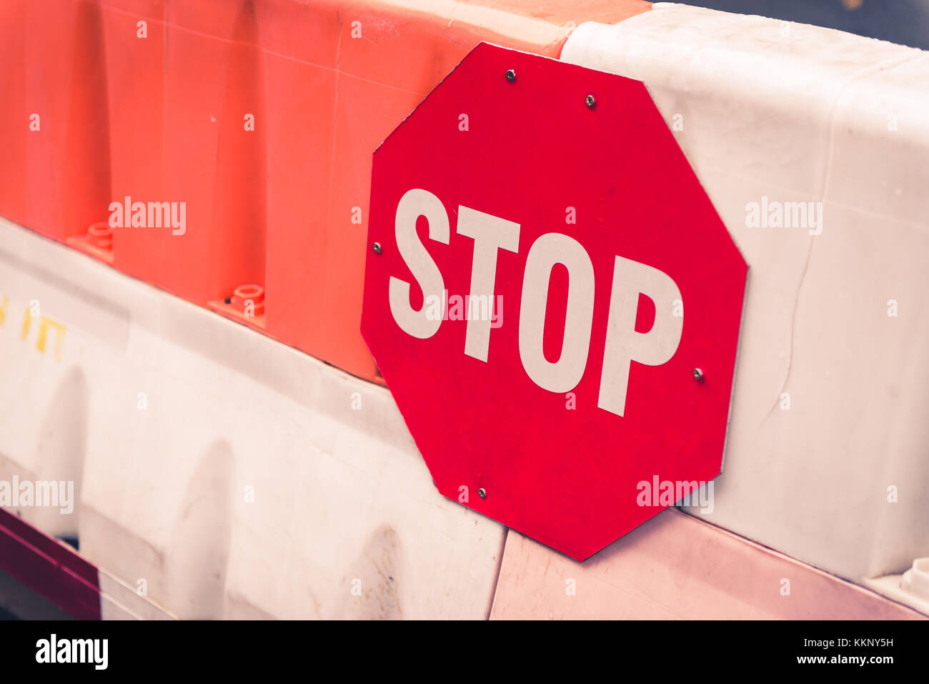 Red stop sign on a block road board Stock Photo - Alamy