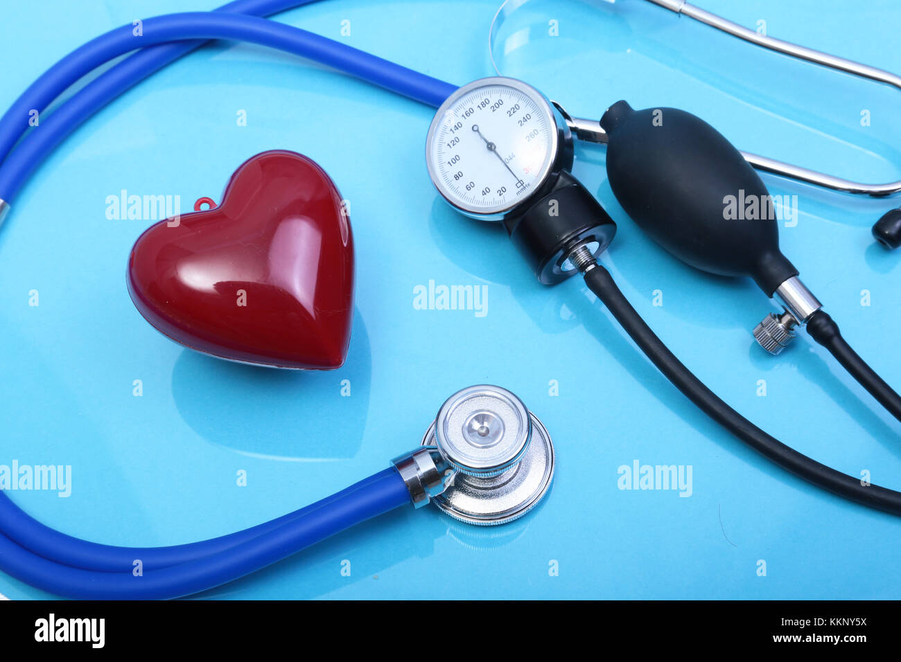 Stethoscope, red heart and medical equipmenton on blue background Stock ...
