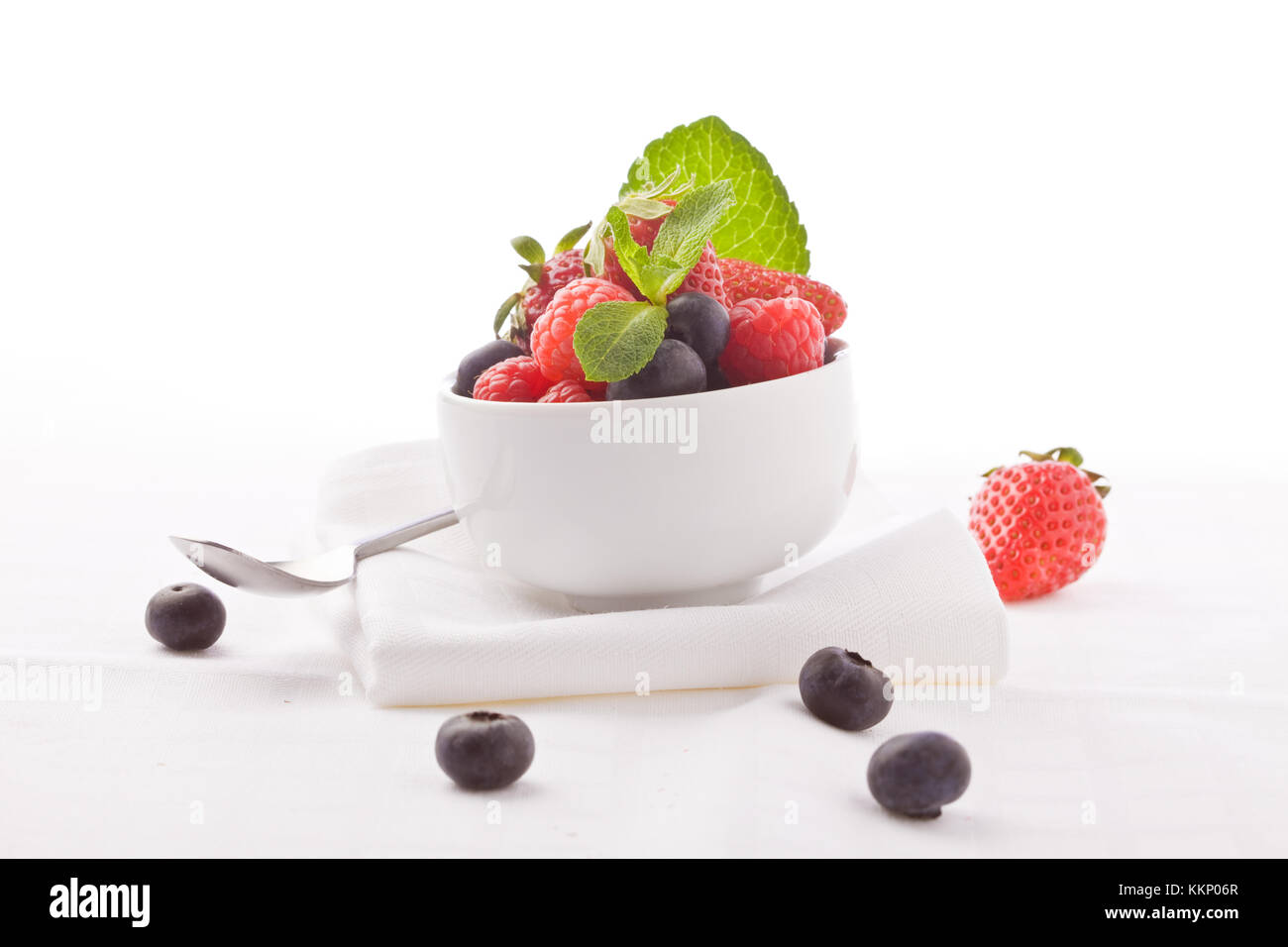 photo of delicious berries with mint on white isolated background Stock ...
