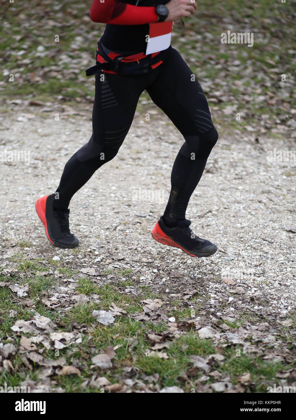 Single runner running in country road during a race with sneakers and ...