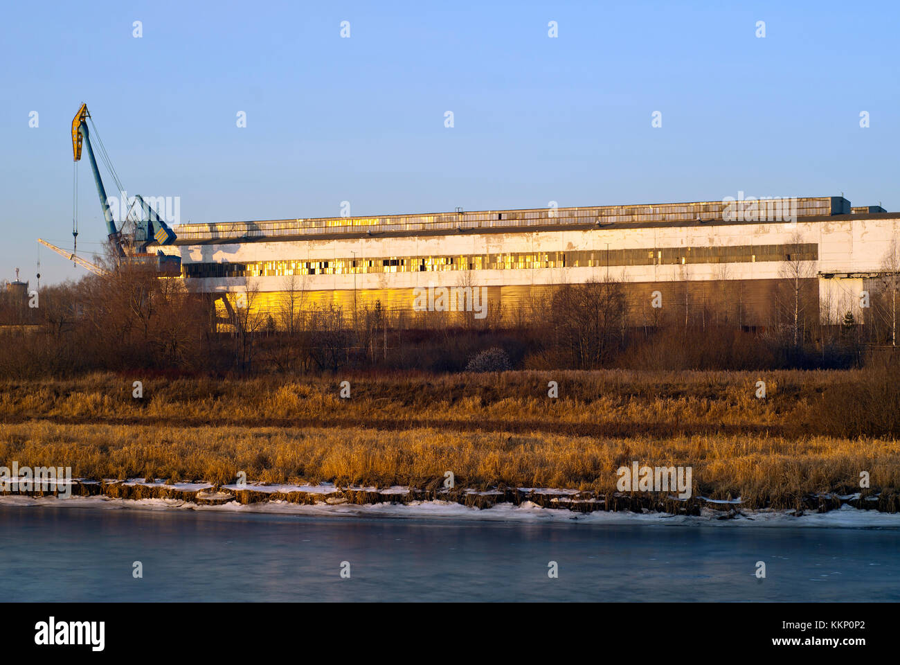 covered dock of ship repair yard for river ships on the overgrown with ...