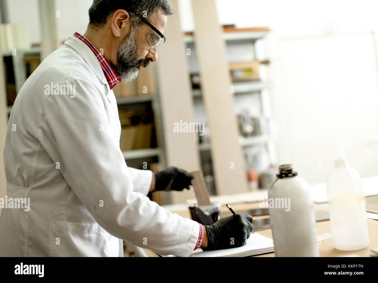 View at engineer in the laboratory examines ceramic tiles Stock Photo ...