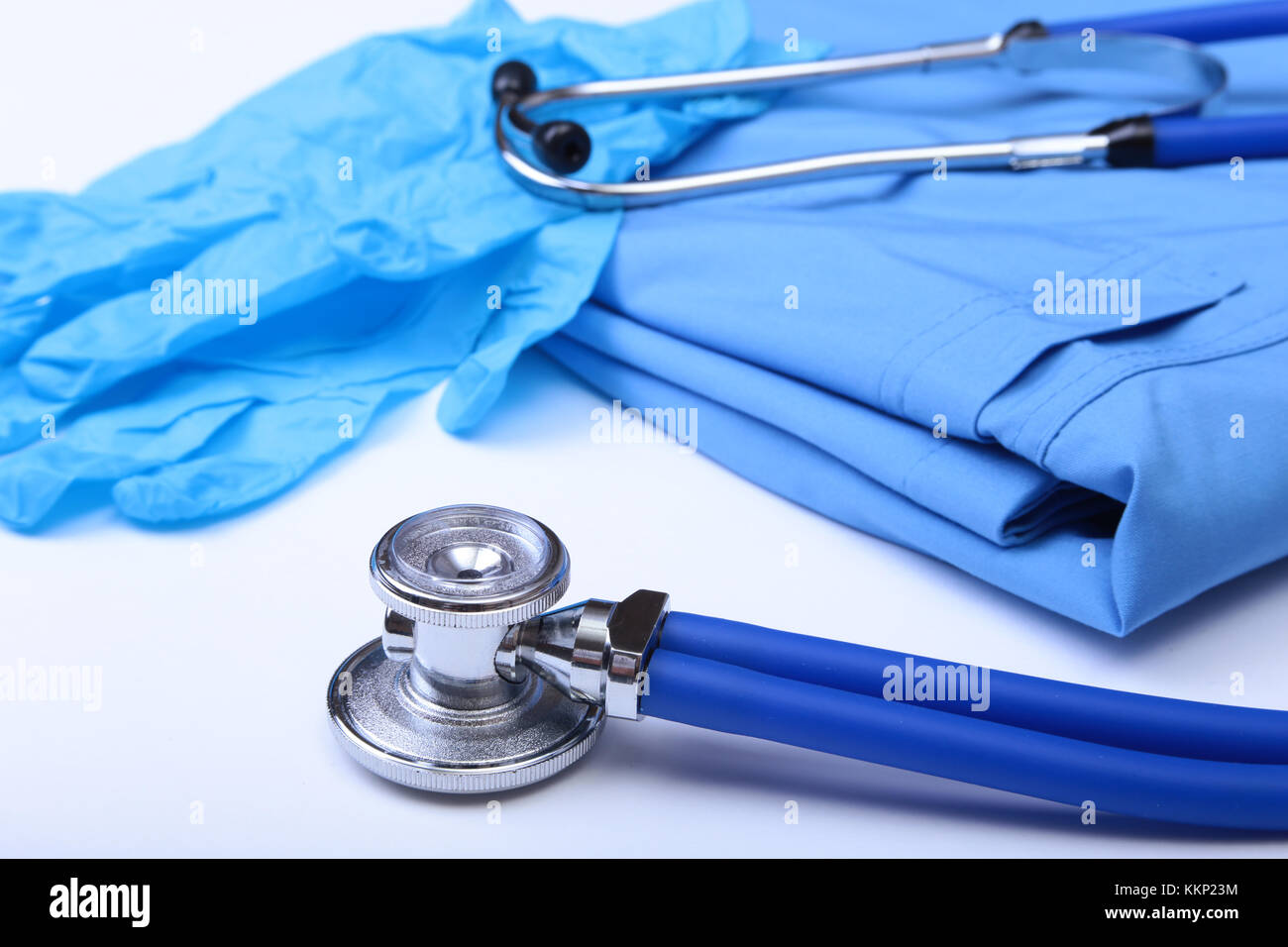 Medical stethoscope head lying on blue doctor uniform closeup. Medical ...