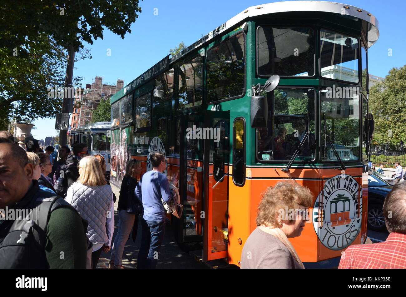 Passengers board a tourist trolley bus near the steps of the ...