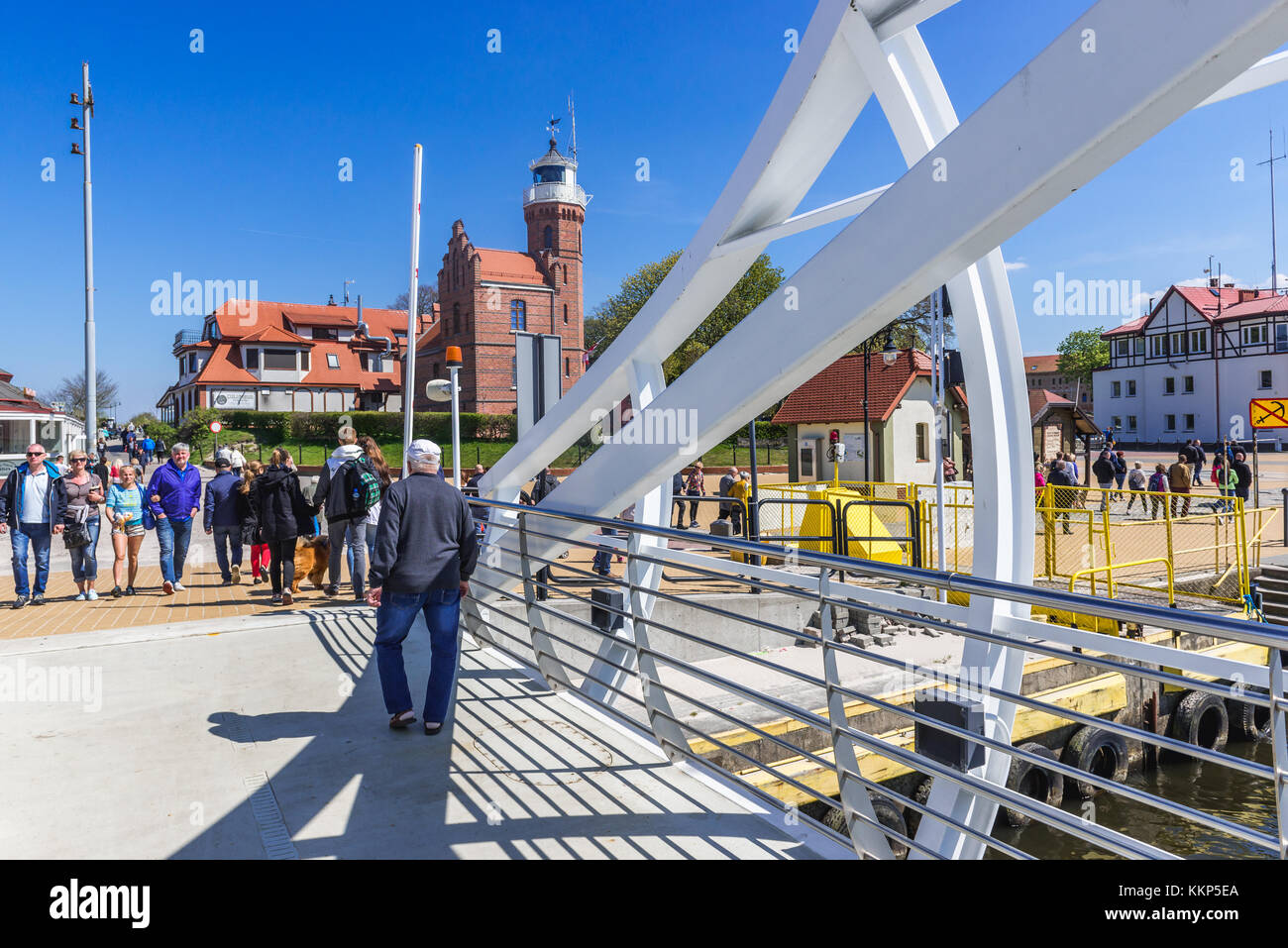 Lighthouse seen from movable footbridge over port channel of Slupia ...