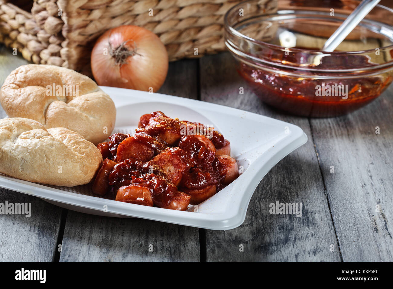 Delicious German currywurst - pieces of sausage with curry sauce and ...