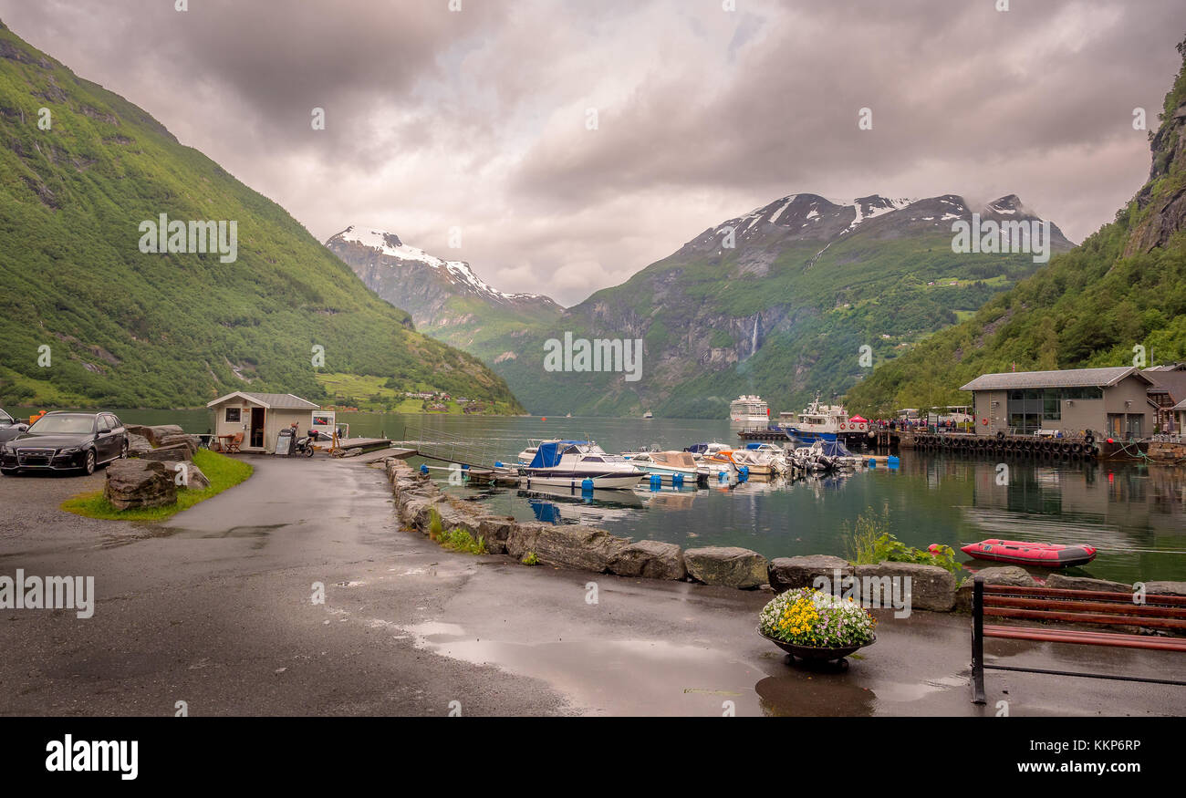 On the dockside in Geiranger, Norway. The fjord in very narrow and ...