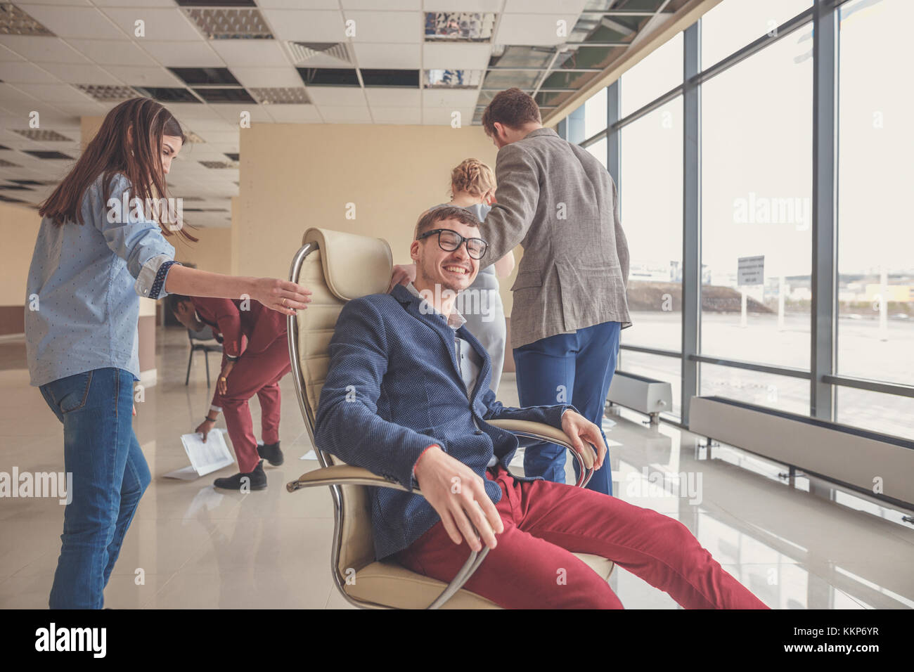 Successful excited Business people group team push colleague sitting in ...