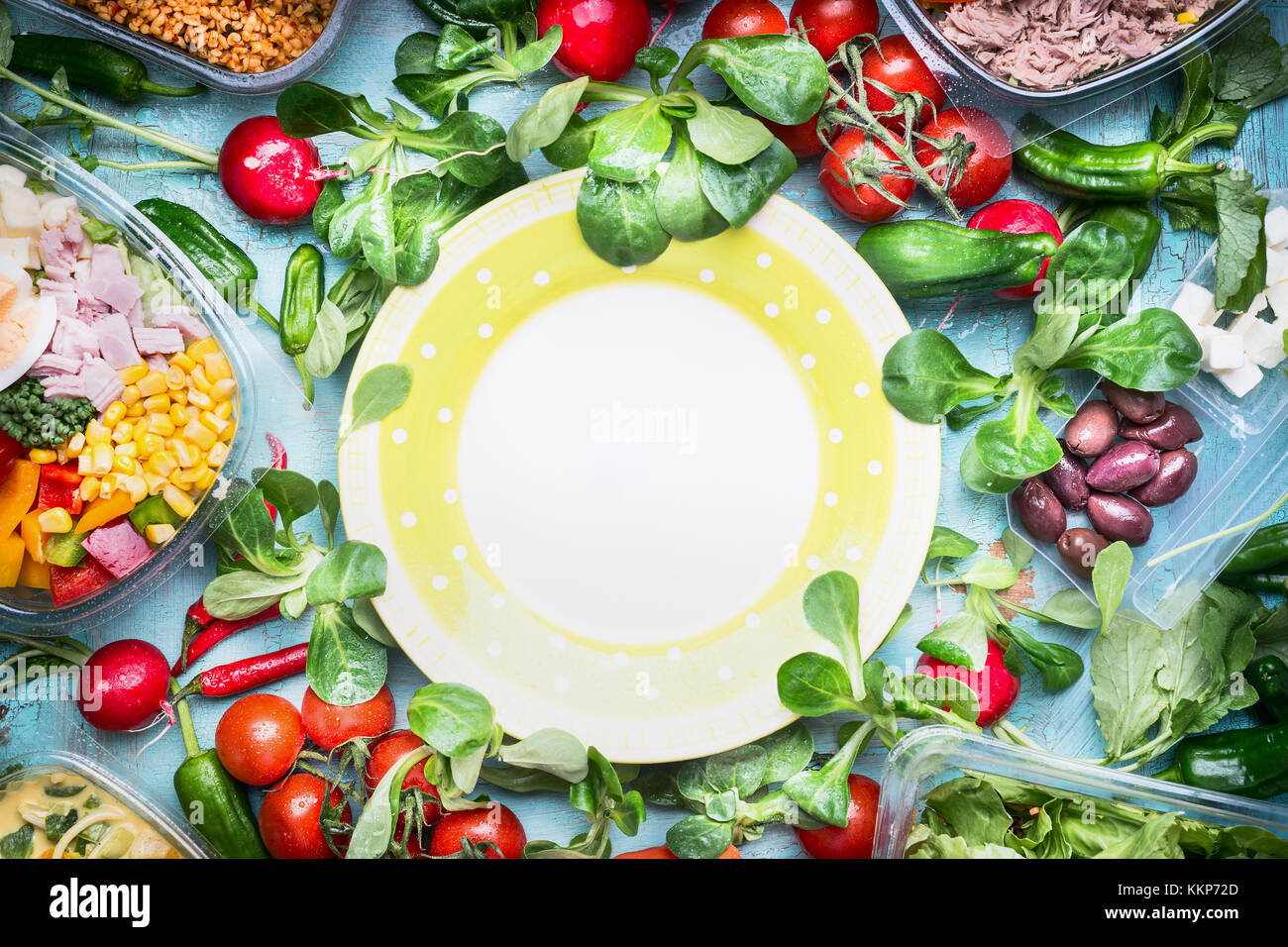 Healthy lunch preparation. Various vegetables and salad bowls in ...