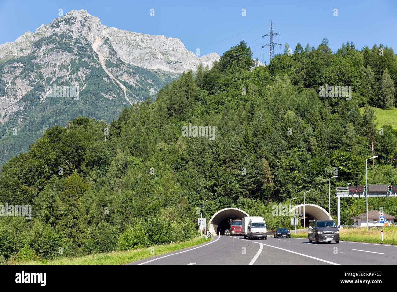 Austrian highway with cars leaving a tunnel through a mountain Stock ...