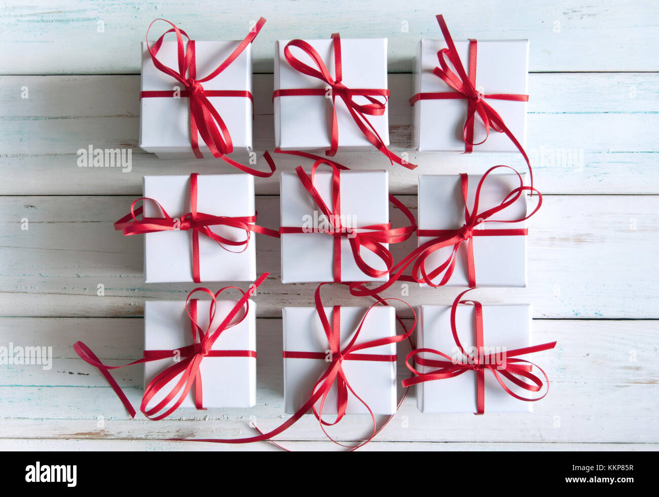 White gift boxes with red ribbon Stock Photo - Alamy