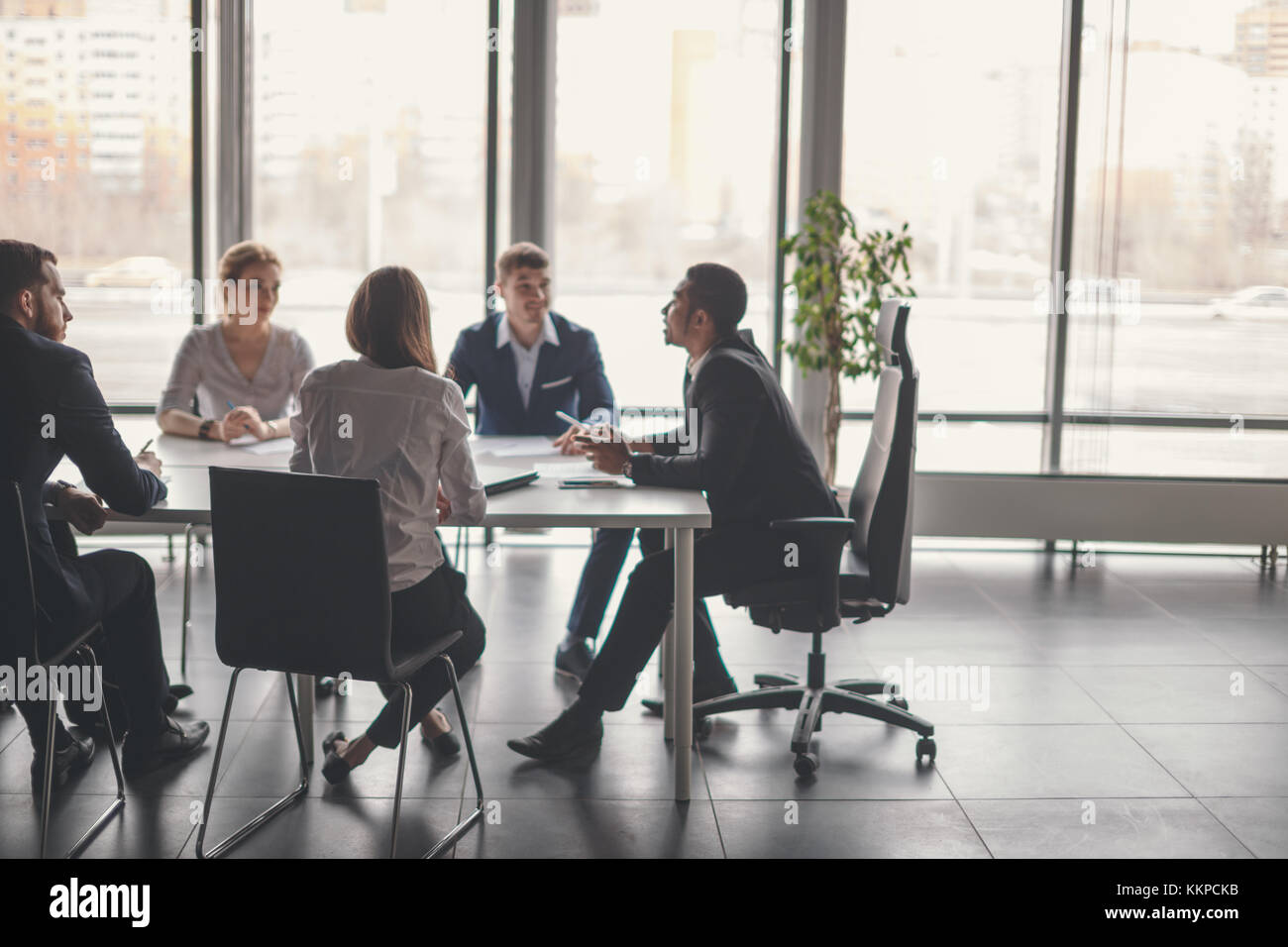 Boss heading a business reunion with partners Stock Photo - Alamy