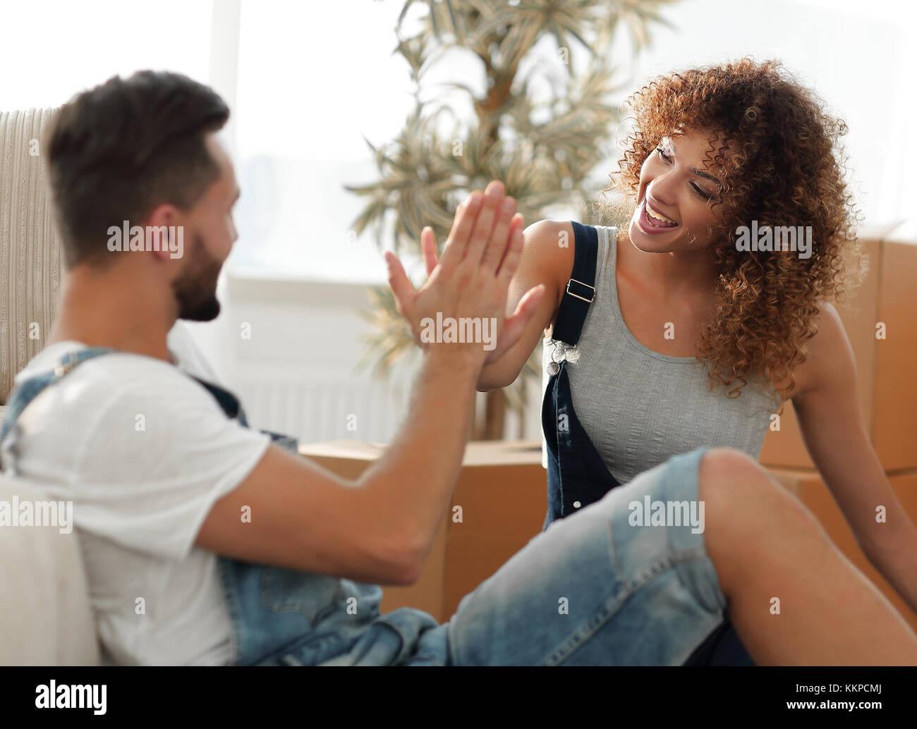 young couple giving each other five with a new home Stock Photo - Alamy
