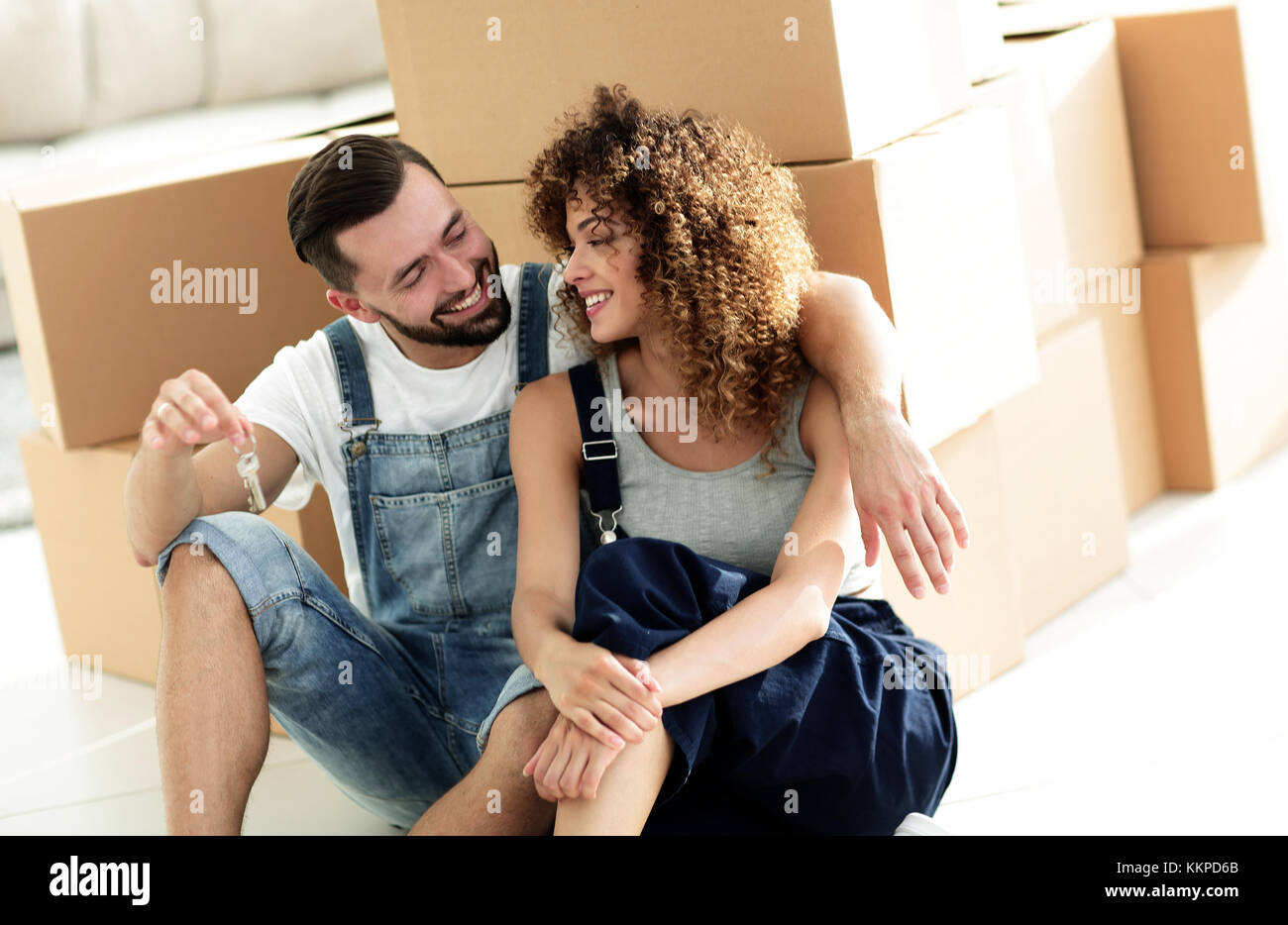 smiling couple on the background of large cardboard boxes Stock Photo ...