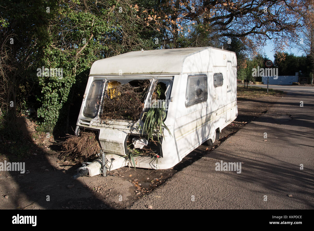 A travellers caravan loaded with garden waste is dumped in the leafy ...