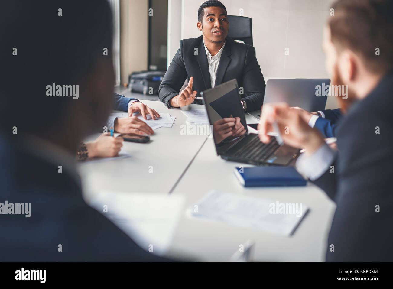 Boss heading a business reunion with partners Stock Photo - Alamy