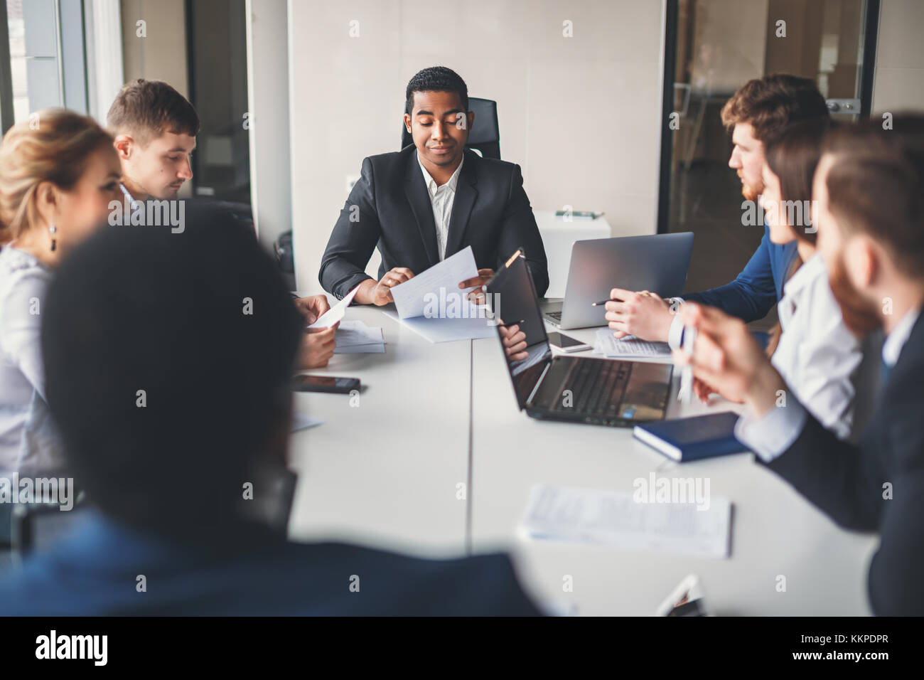 Boss heading a business reunion with partners Stock Photo - Alamy