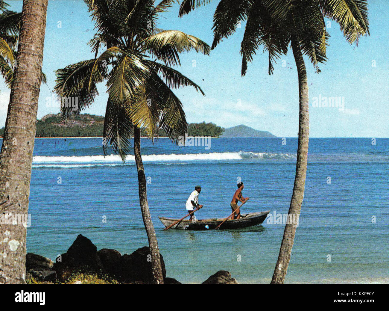 This image captures a traditional pirogue, a small fishing boat used by ...