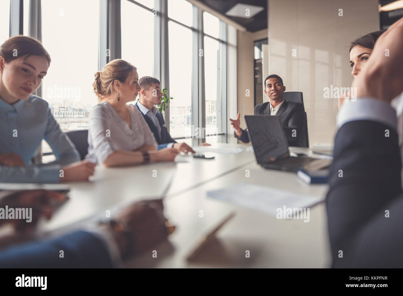 Boss heading a business reunion with partners Stock Photo - Alamy