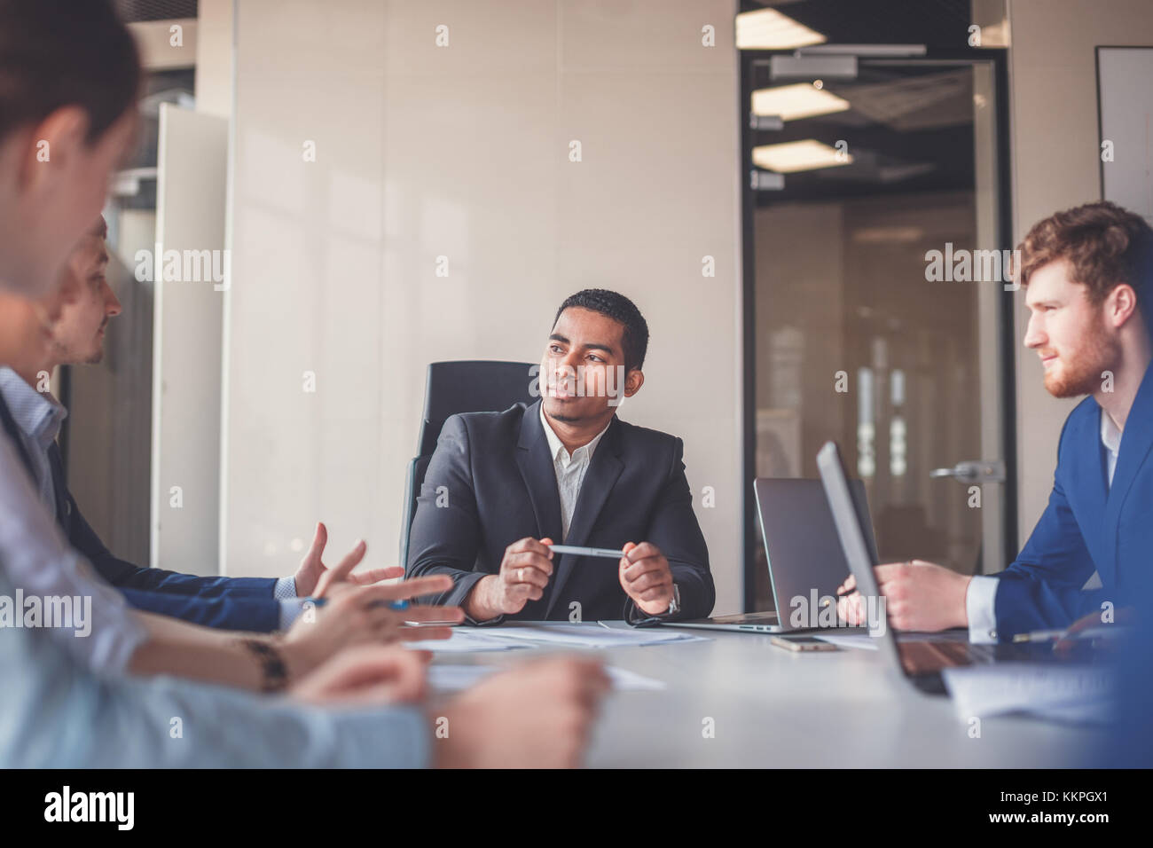 Boss heading a business reunion with partners Stock Photo - Alamy