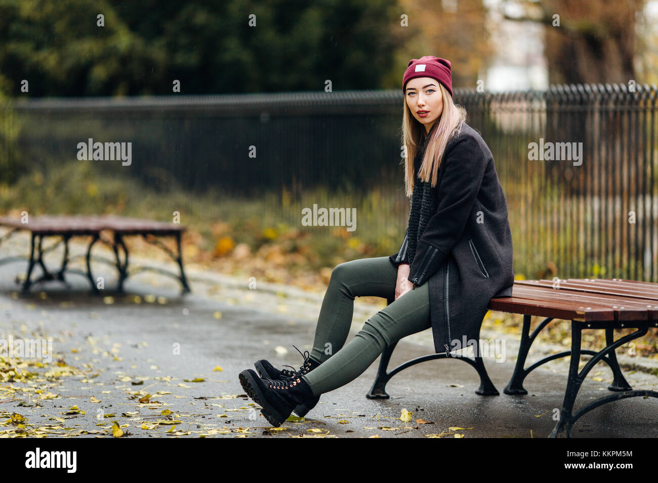 Girl sit on the bench and wait for her friends Stock Photo - Alamy