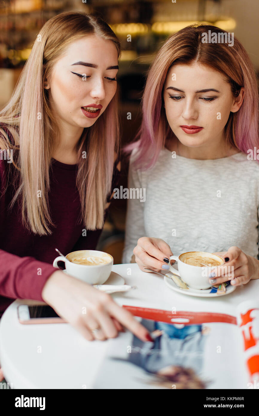 Two girls meat at coffee place and talk to each other, make ...