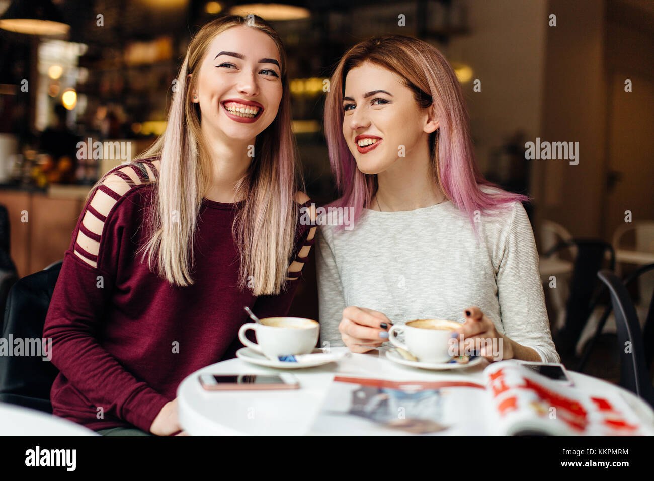 Two girls meat at coffee place and talk to each other, make ...