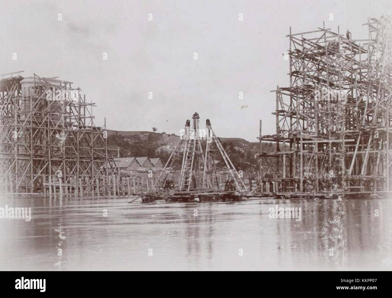 A historical photo depicting the construction of a bridge over the ...