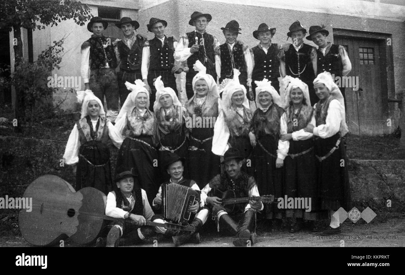 This image captures a Slovenian cultural scene from 1950, showcasing ...