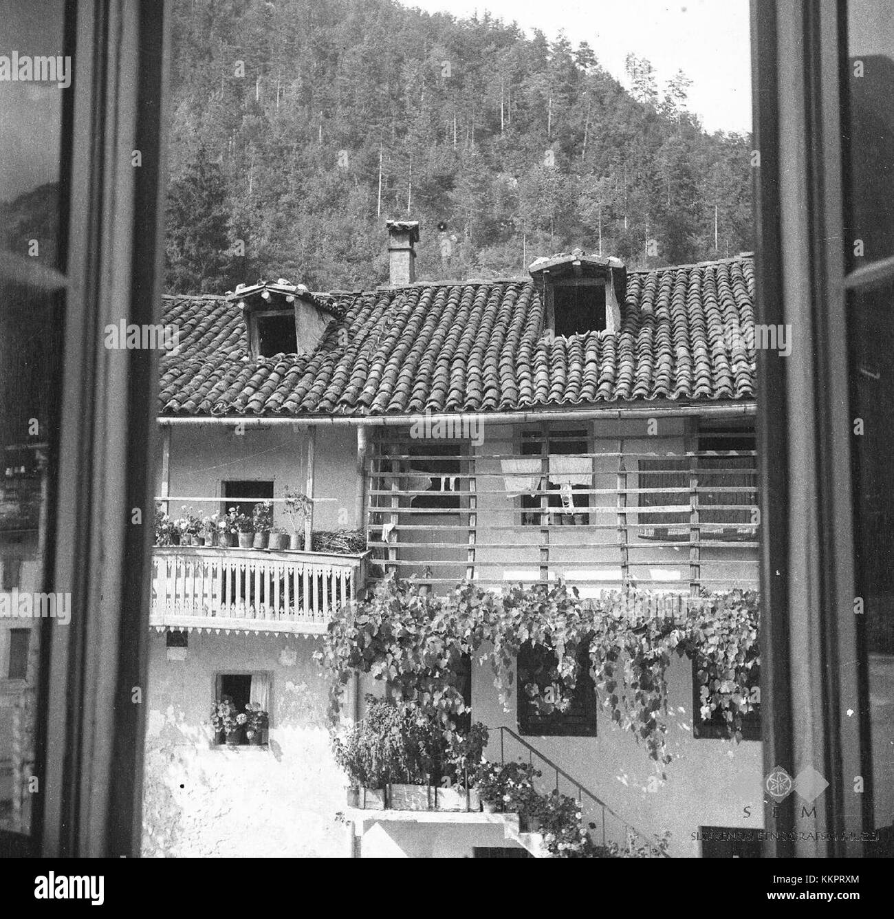 'Pogled z okna v Kobaridu 1951' depicts a scenic view from a window in ...