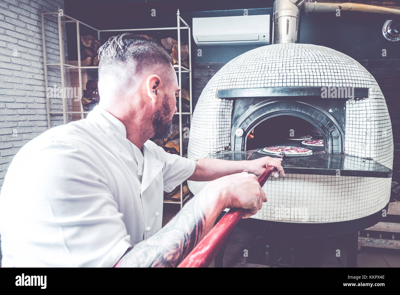 Pizza chef in action at local pizzeria business Stock Photo - Alamy