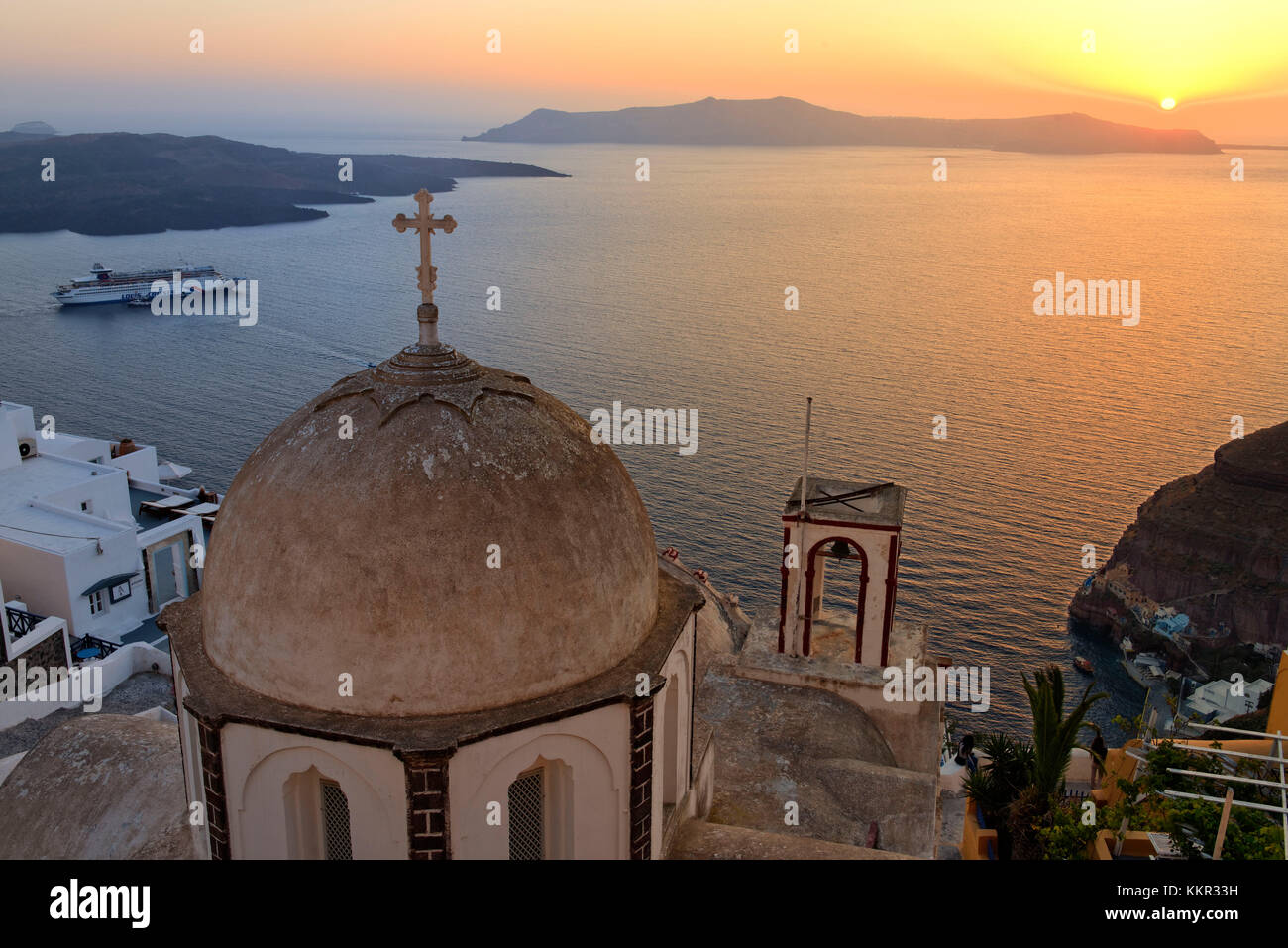 Church dome in the steep slope of Fira with view over the Caldera in ...
