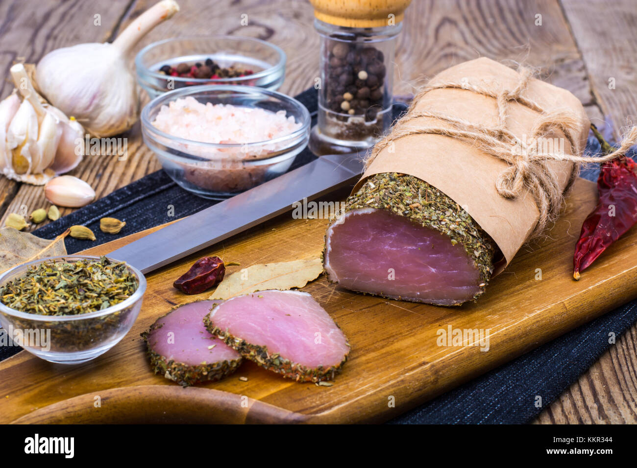 Piece of smoked Ham with garlic and spice on wooden background. Rustic ...