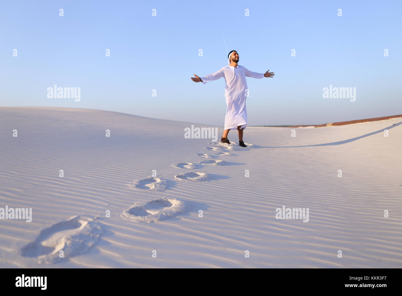 Confident Arabian tourist guy walks on foot along expanses of white ...