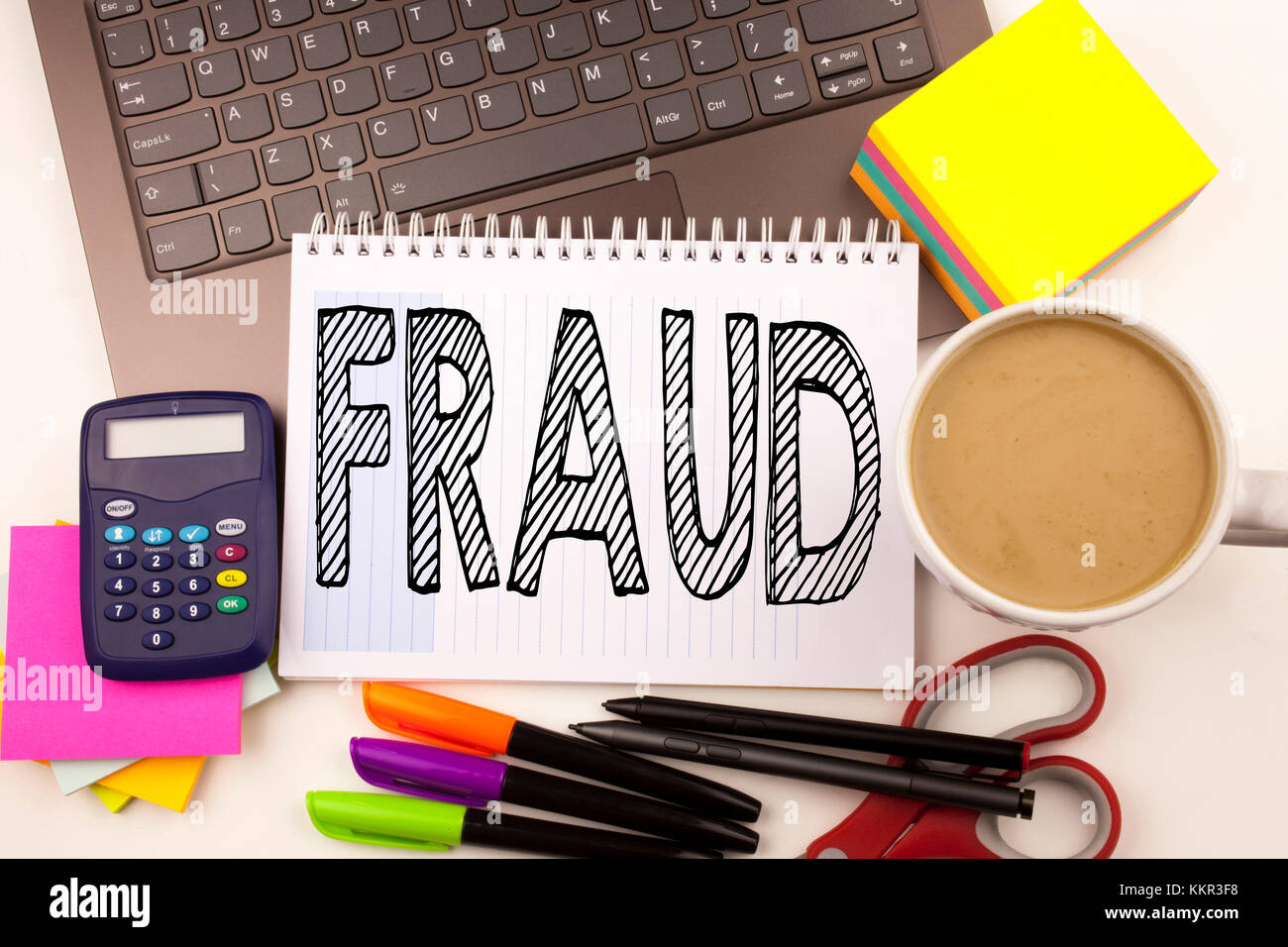 Word writing Fraud in the office with laptop, marker, pen, stationery ...