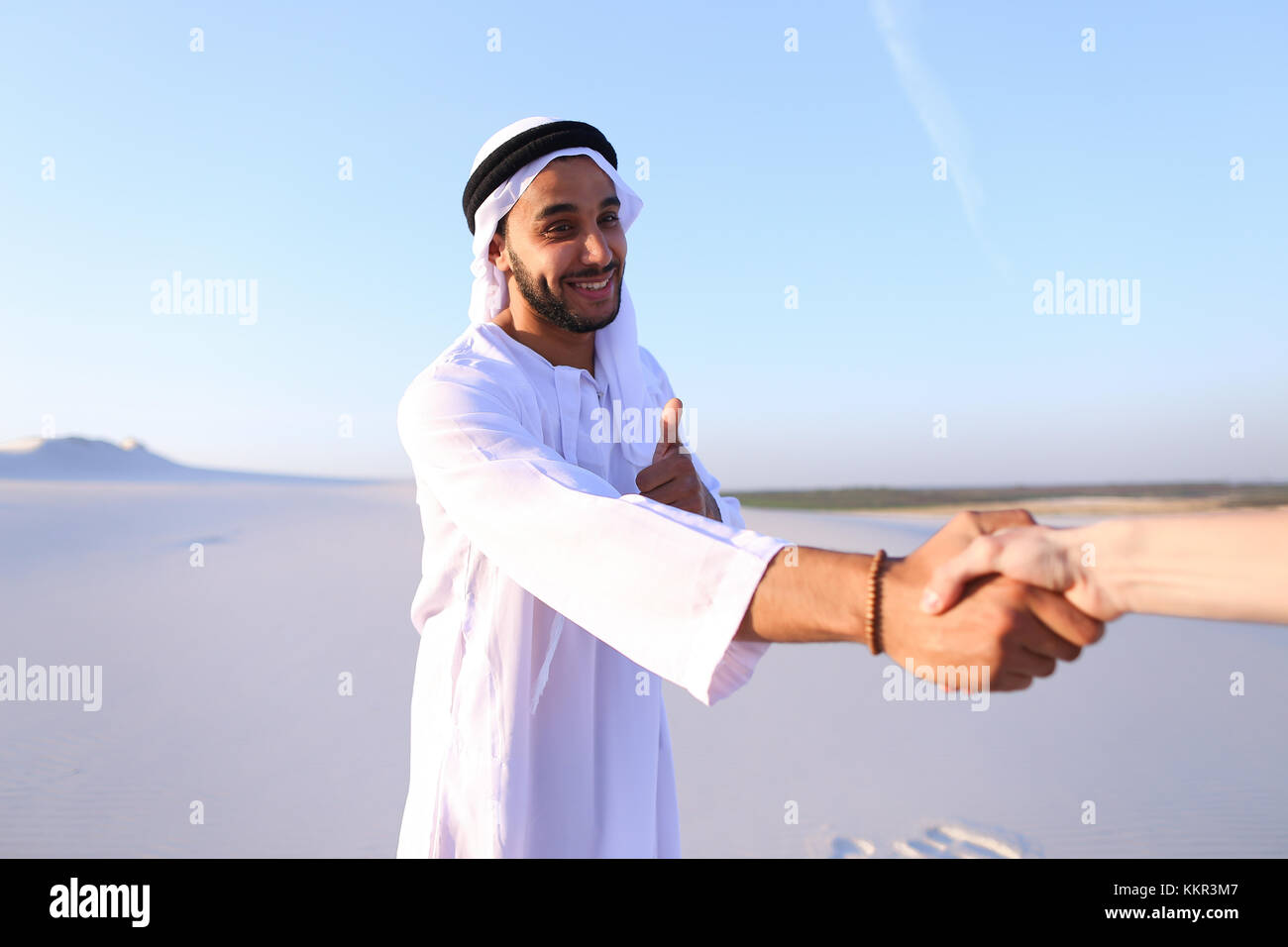Portrait of Muslim male sales representative who with friendly look and ...